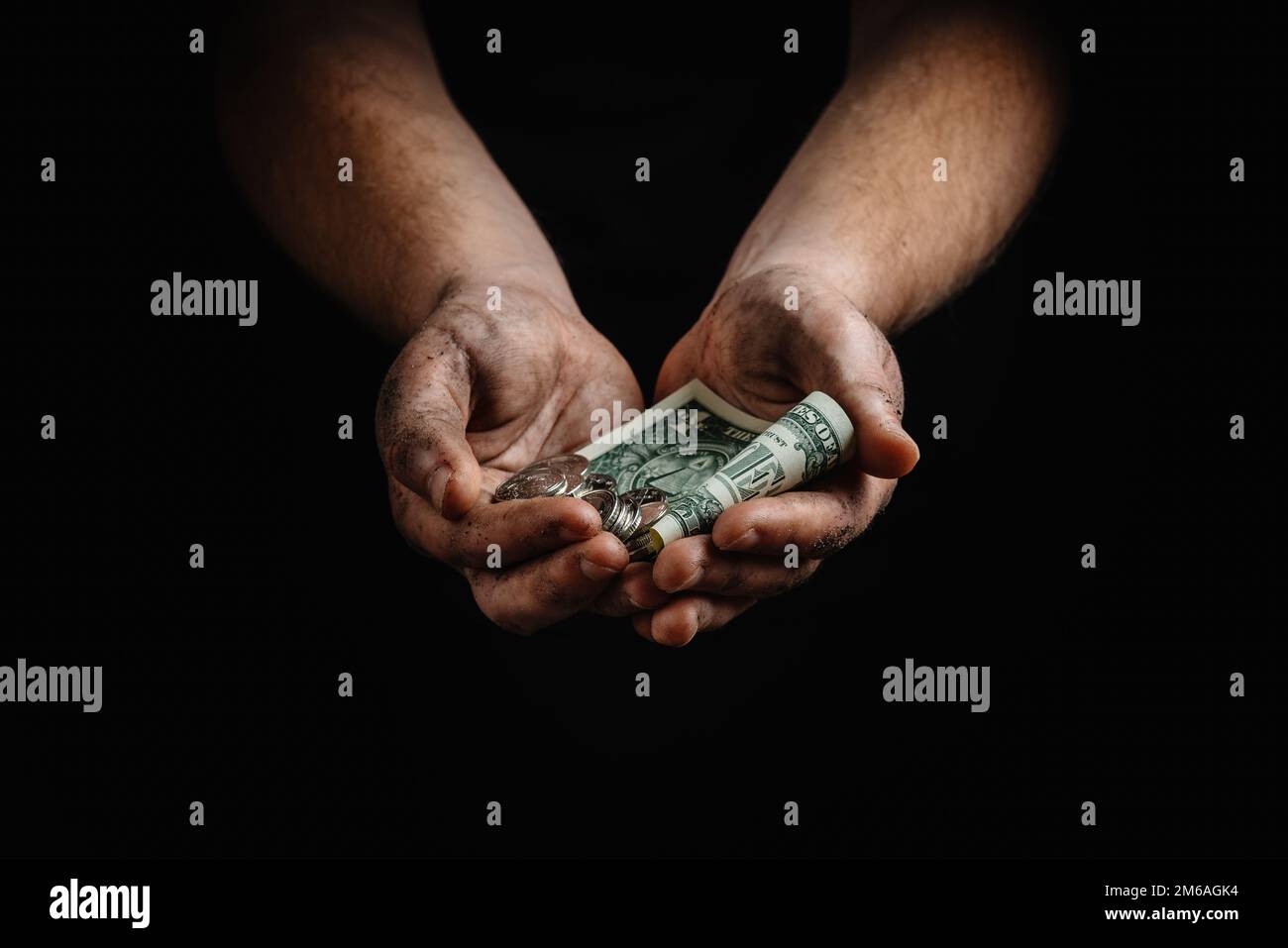 The dirty hands of a homeless man, a poor man holding not much money ...