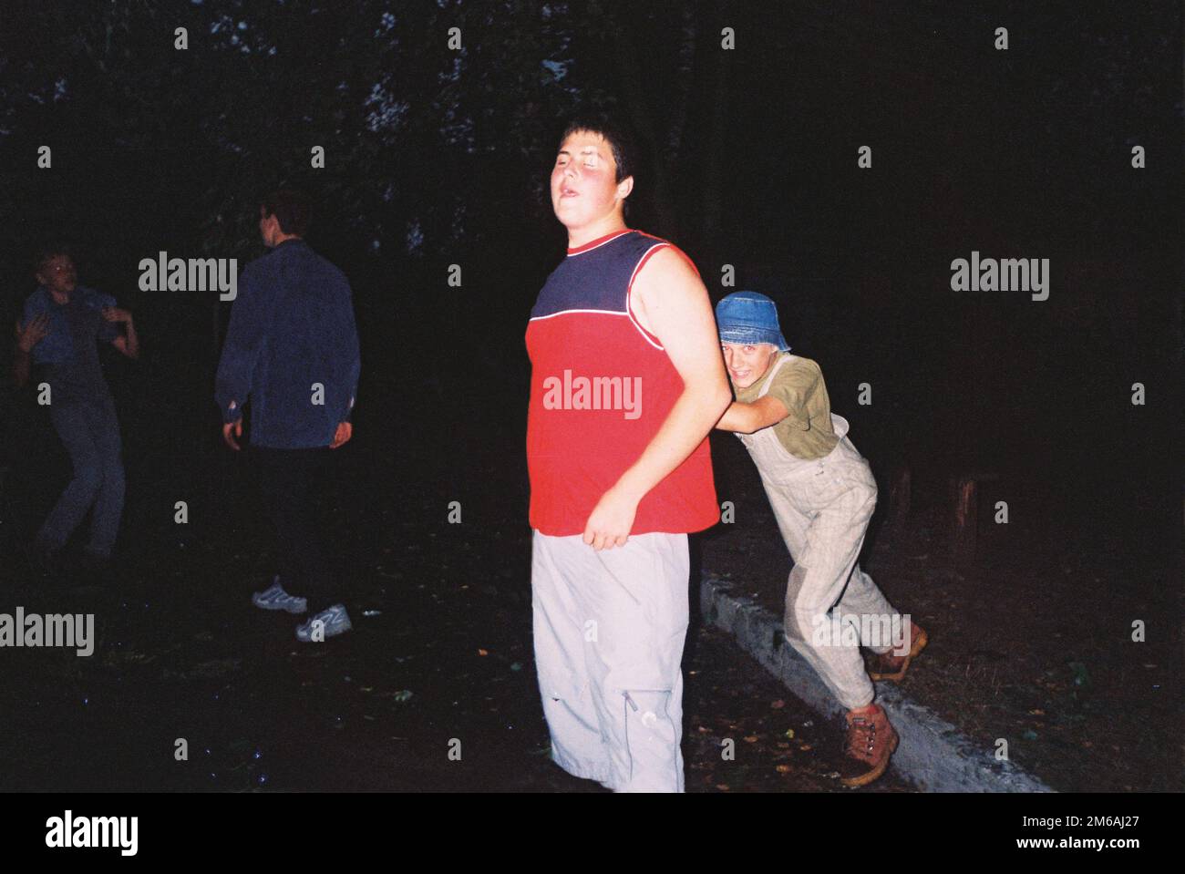 shuffle boy pushes big guy at night Stock Photo - Alamy