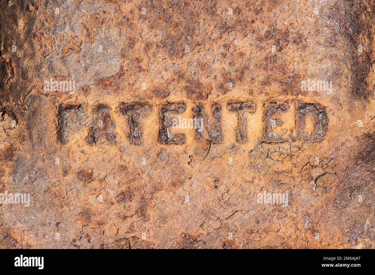 Old weathered rusty cast iron surface labeled pat Stock Photo - Alamy