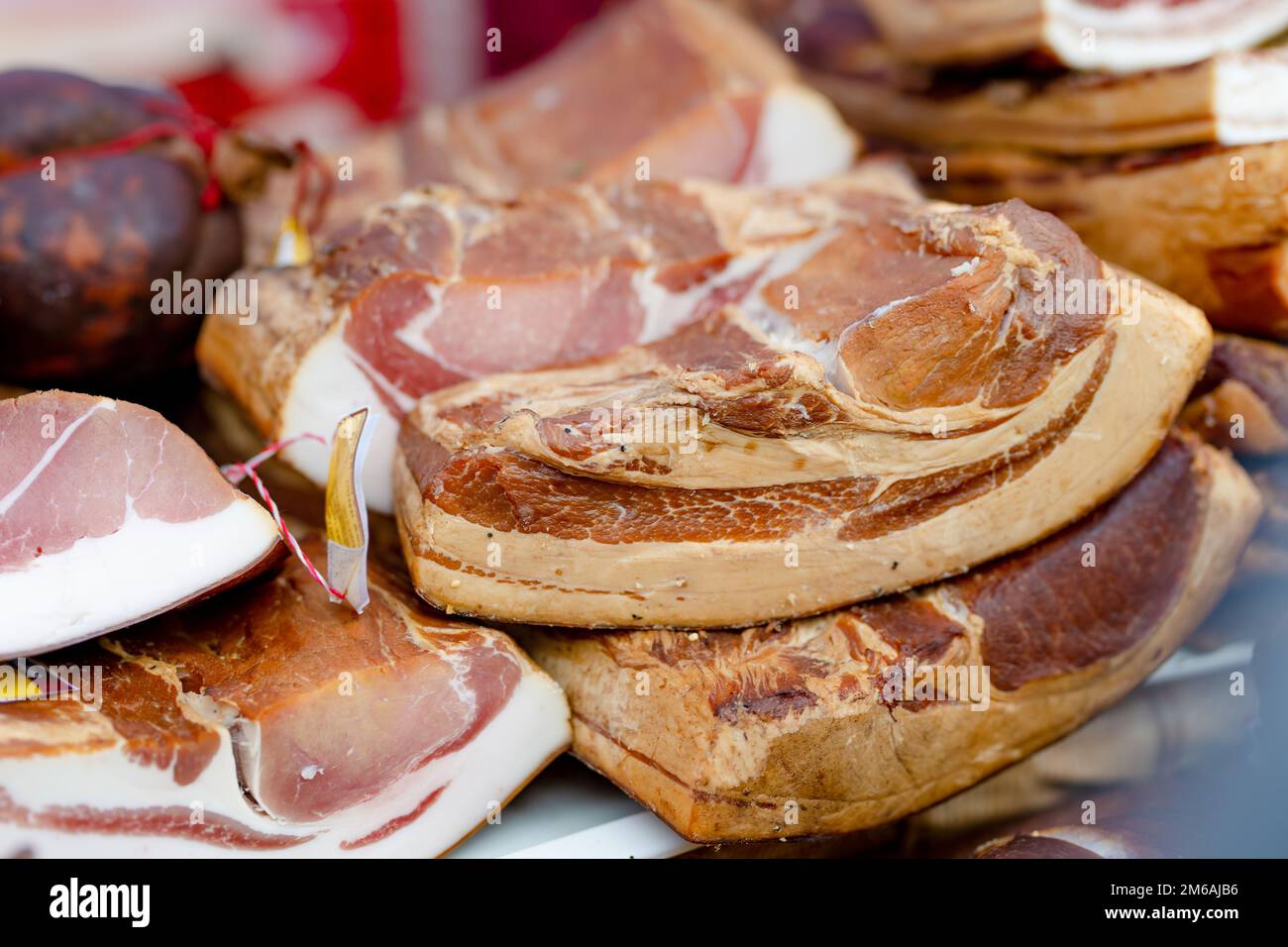 Selection of assorted home made meats, jerky and sausages on a farmers ...