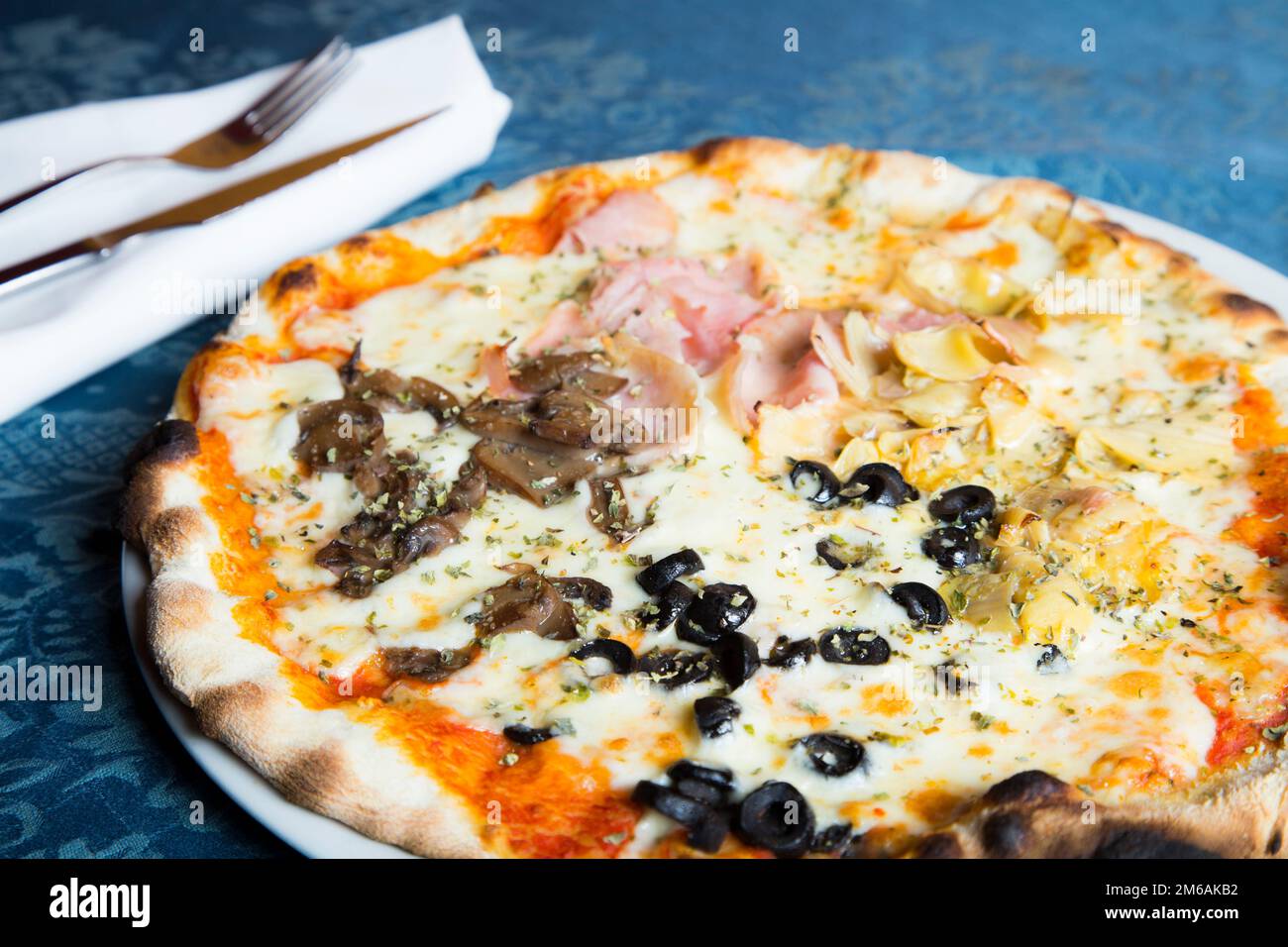 Four Seasons Pizza. Neapolitan pizza with tomato sauce, cheese, ham ...