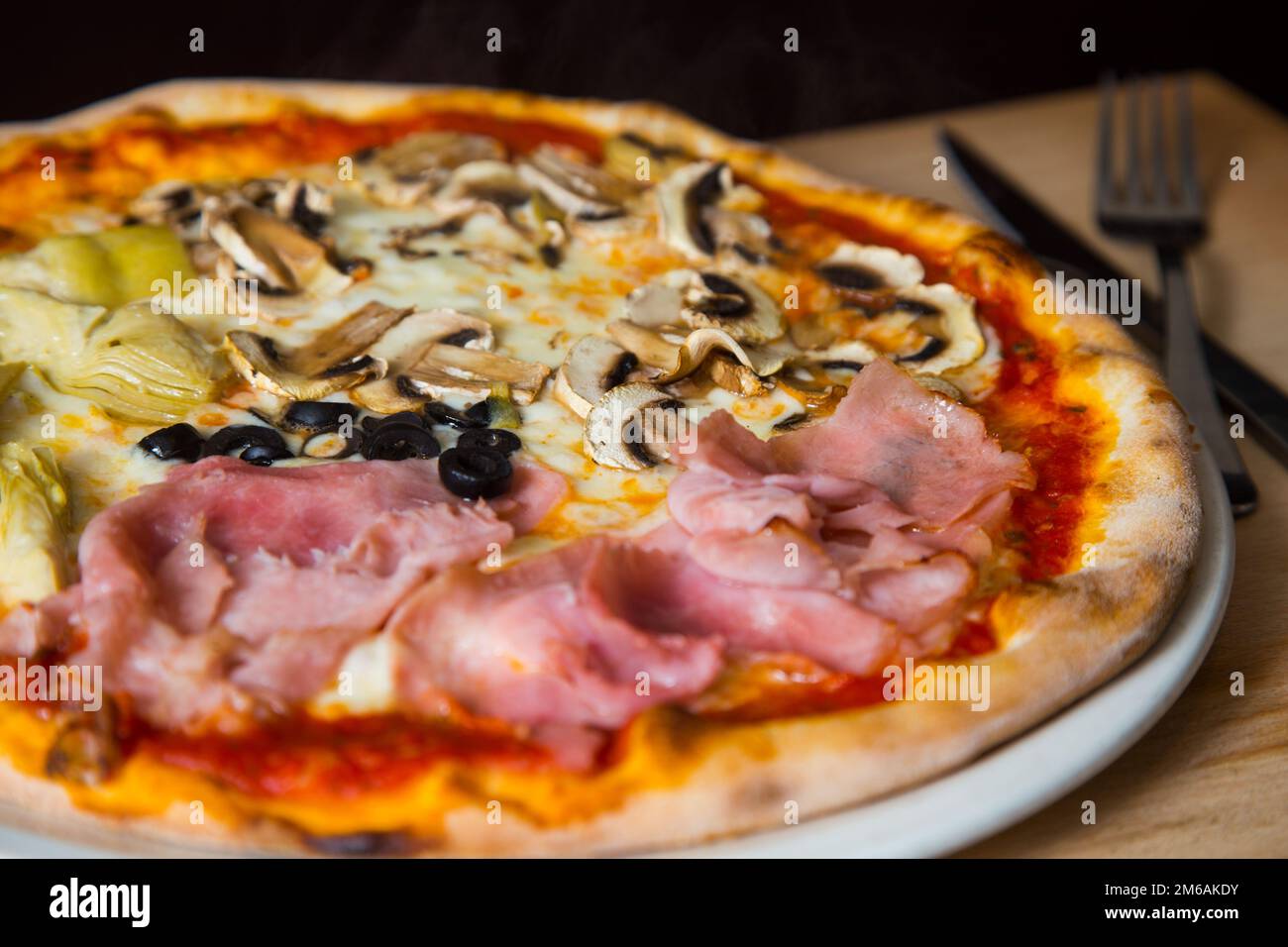 Four Seasons Pizza. Neapolitan pizza with tomato sauce, cheese, ham ...