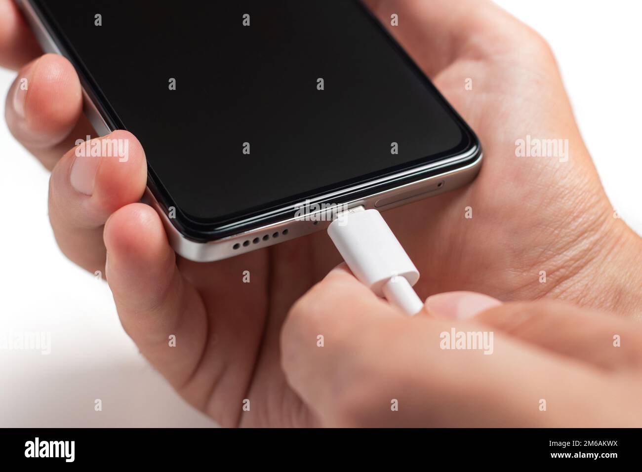 Man hands plugging a charger in a smart phone. Man using smartphone ...