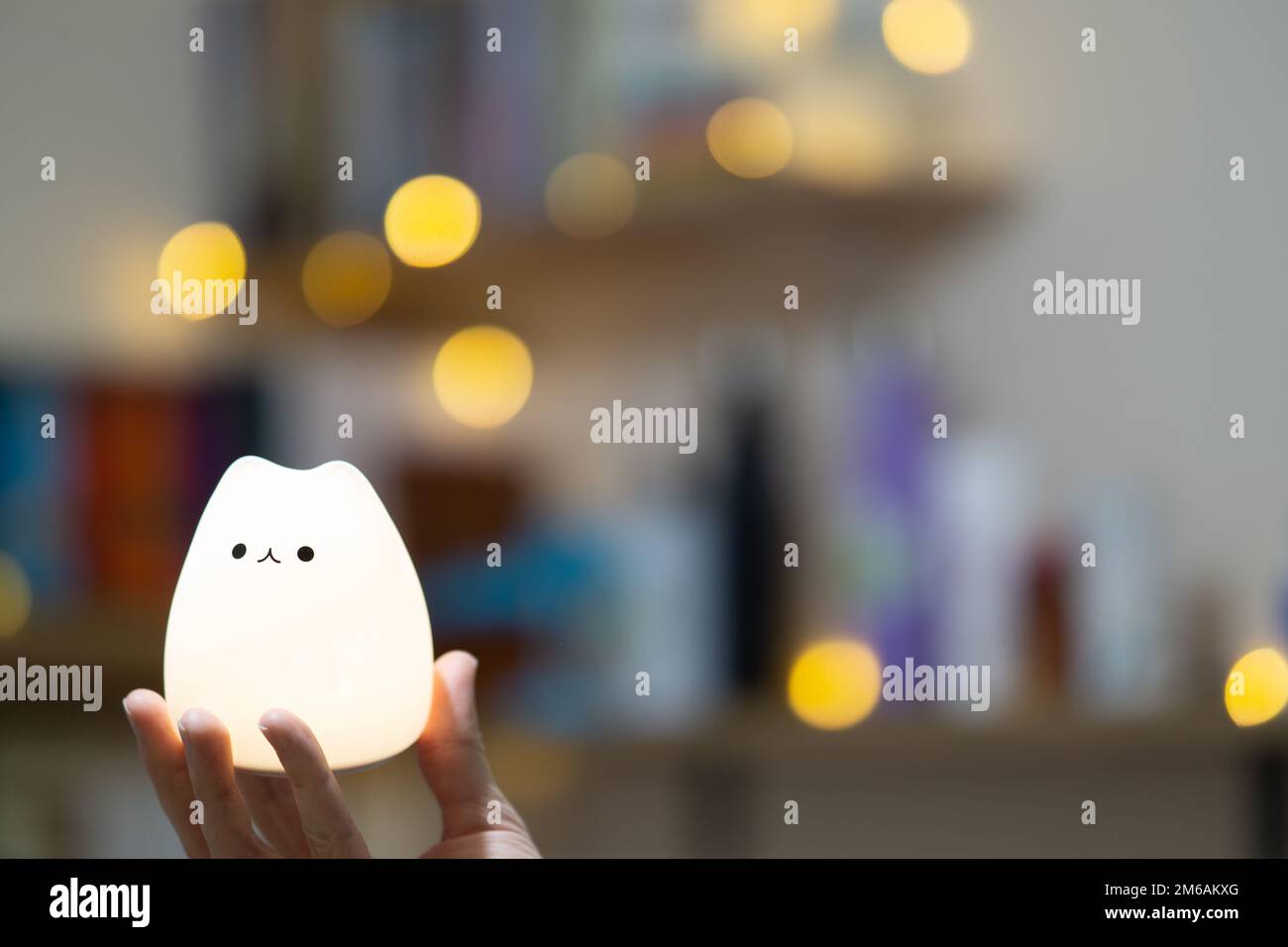 Cute cat silicone night lamp. Man's hand holding cute cat shaped ...