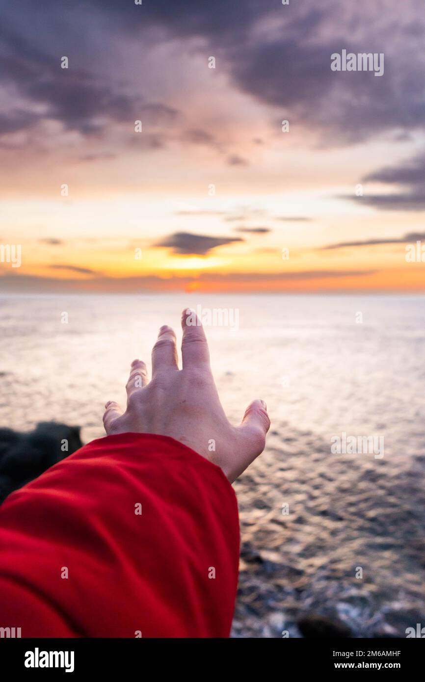 Hand pointing sunset hi-res stock photography and images - Alamy
