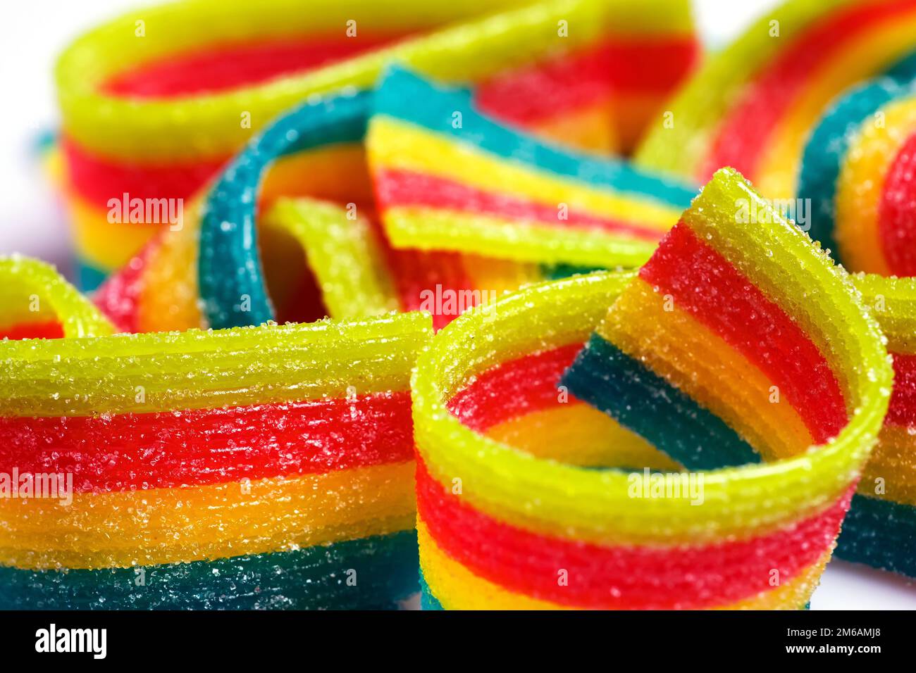 Colorful jelly candies strips in sugar sprinkles. Sour flavored rainbow ...