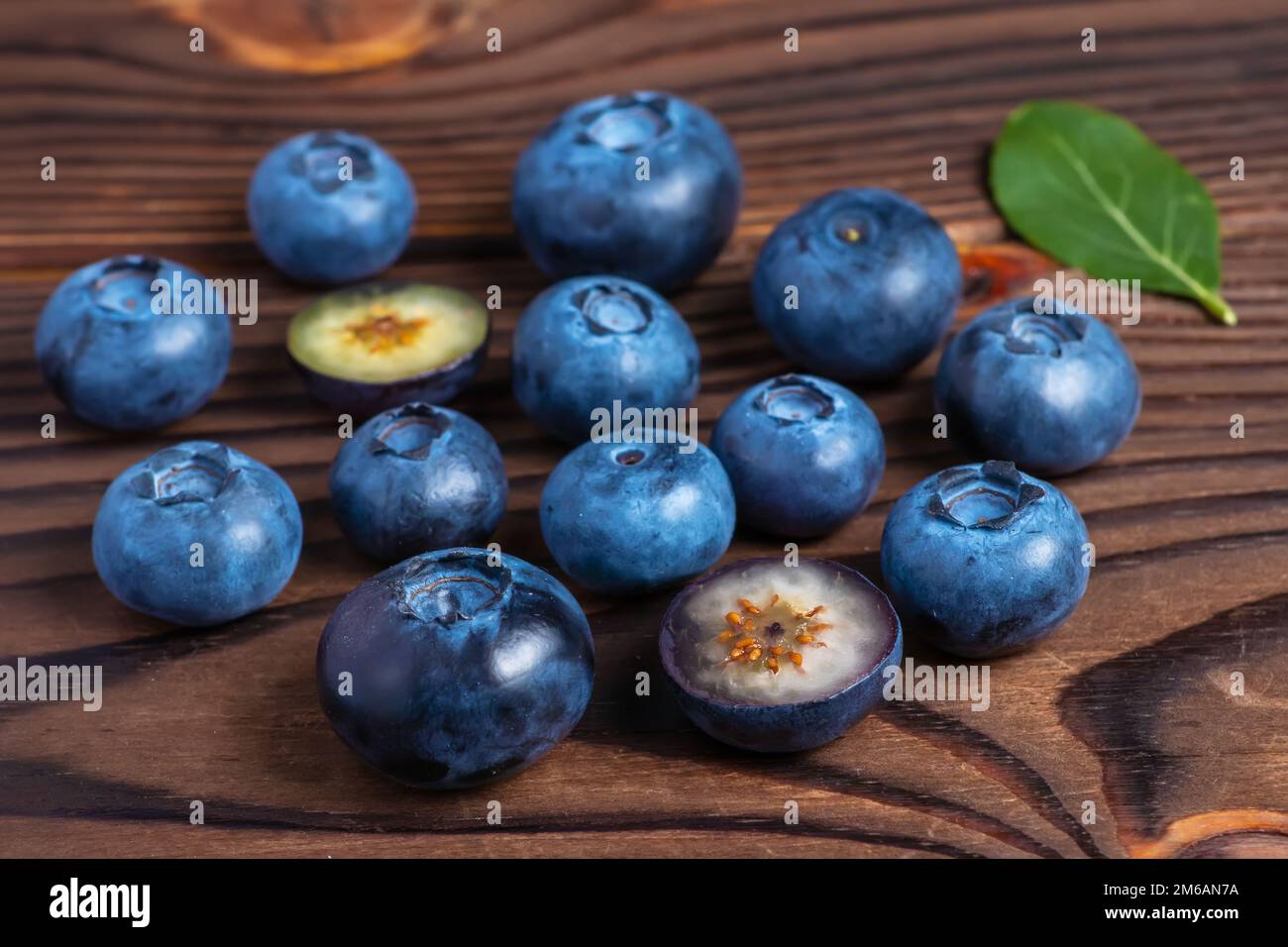 fresh Blueberries with cut in half on wooden background Stock Photo - Alamy