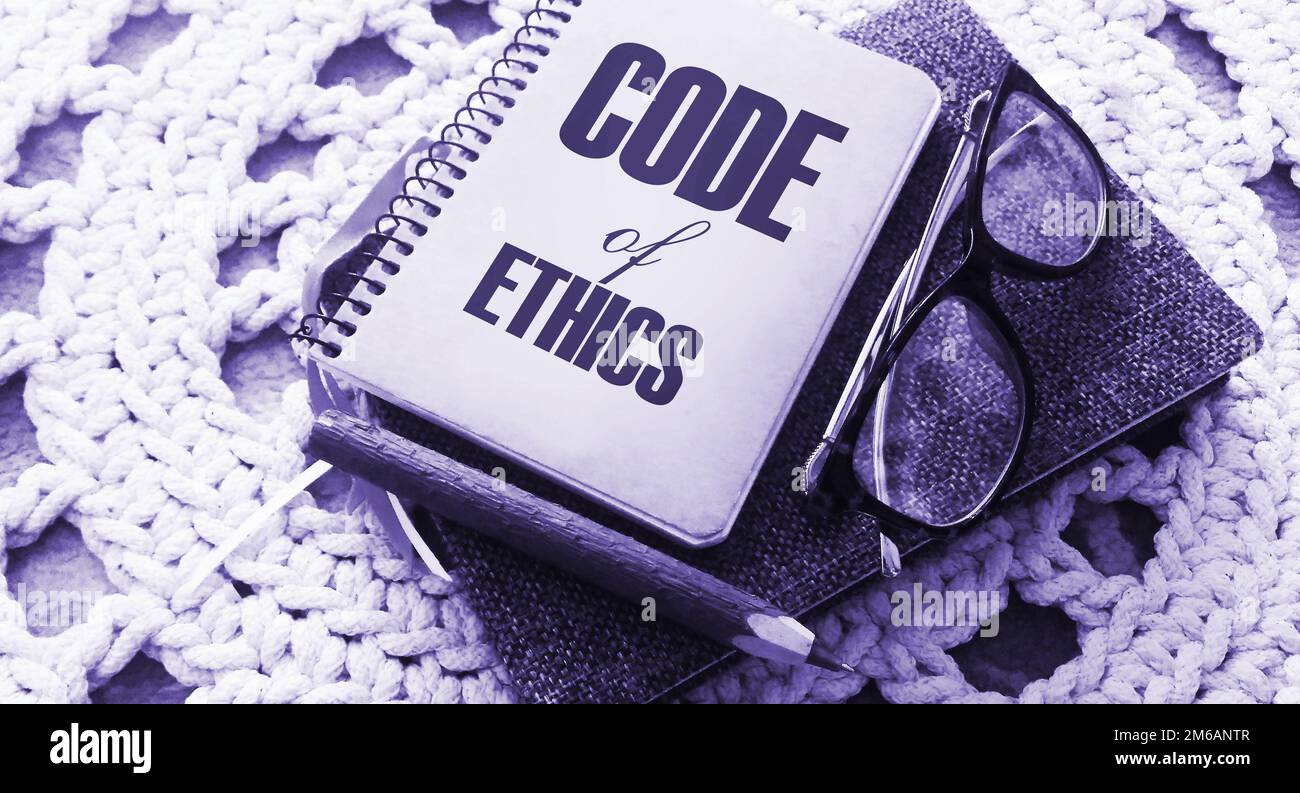 Code Of Ethics words on notebook, pen, glasses, crochet cloth. Business ...