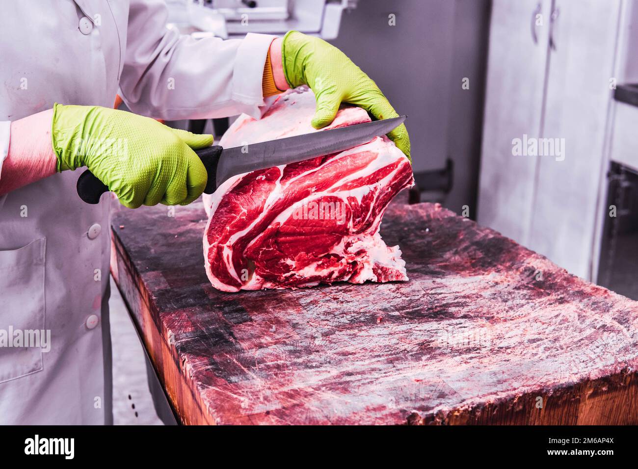 butcher cutting a ribeye with the knife Stock Photo - Alamy