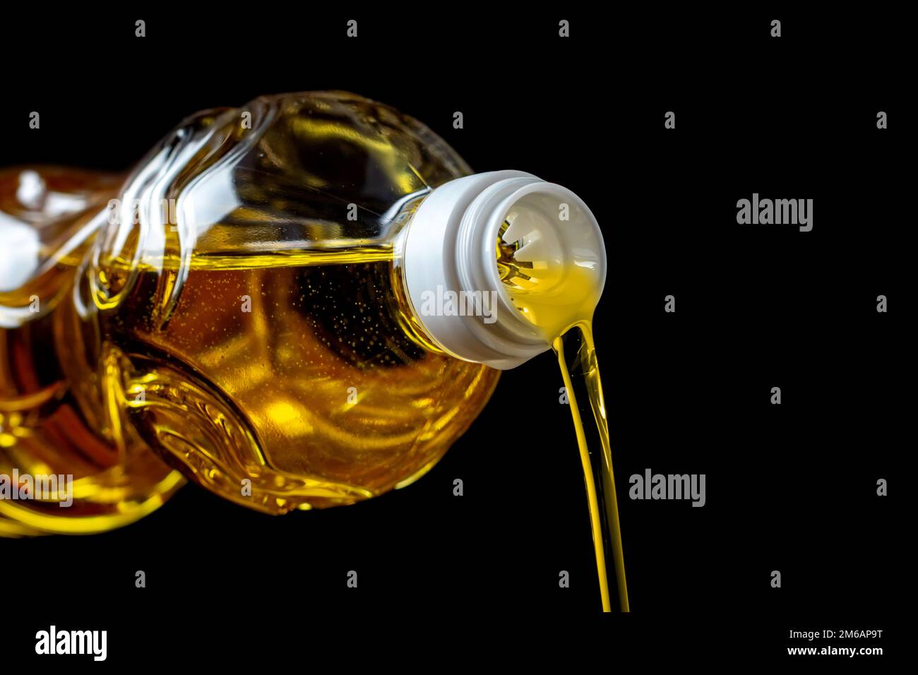 Vegetable oil pouring on vegetable oil black background Stock Photo - Alamy