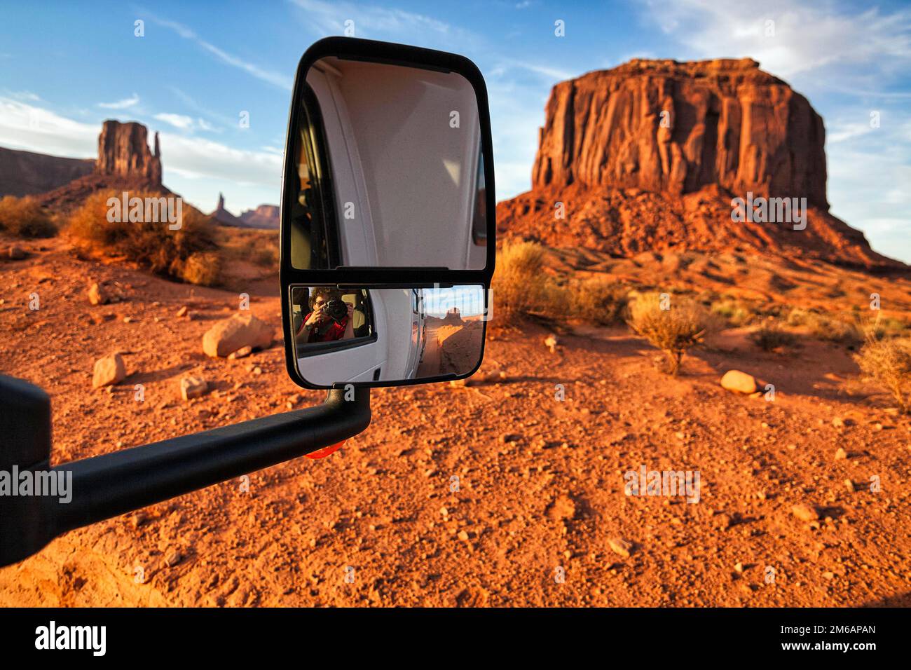 Motorhome on gravel road in front of striking rock formation, West ...
