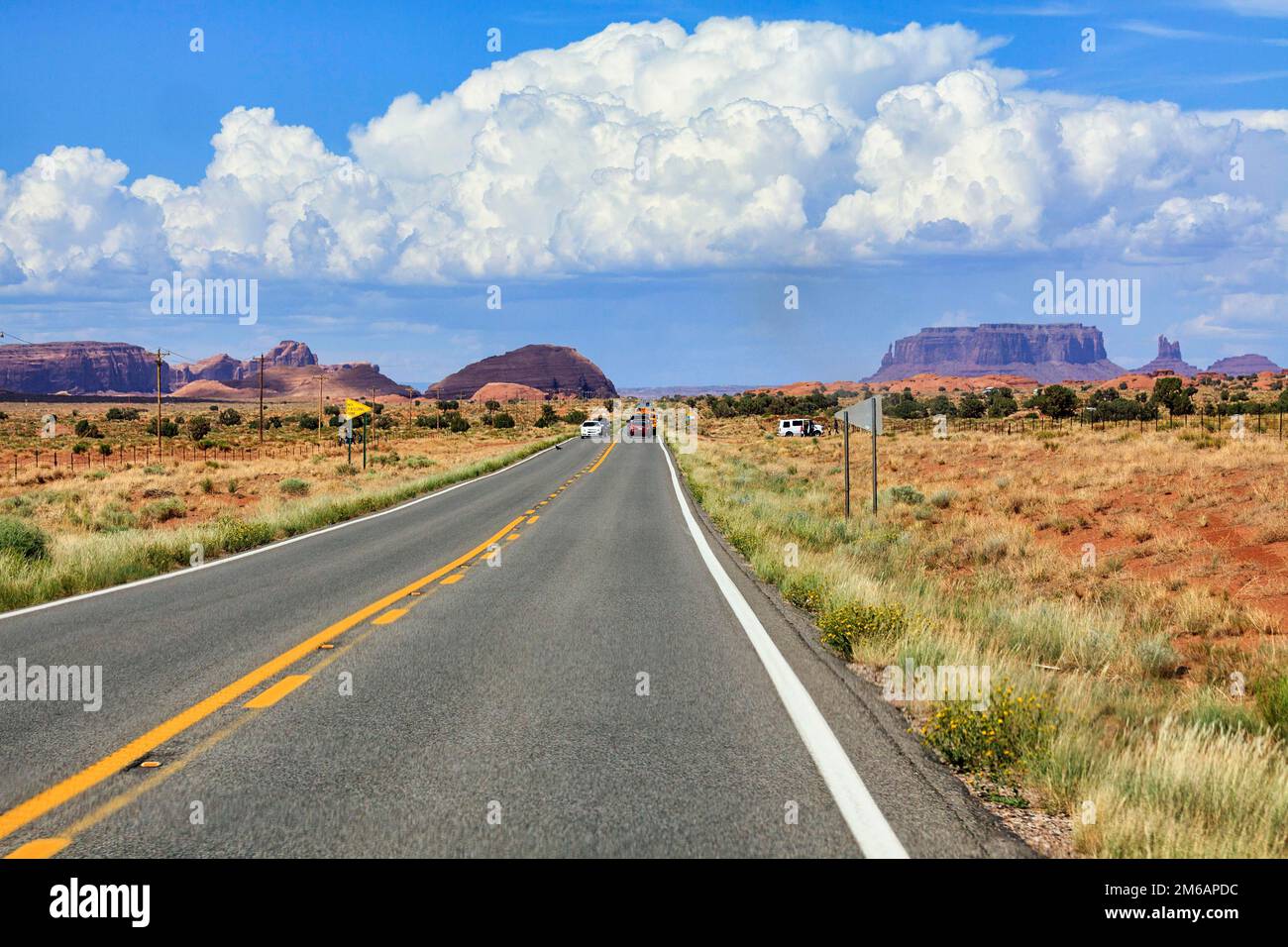 Road leads across a plateau, Table Mountains on the horizon, Kayenta ...