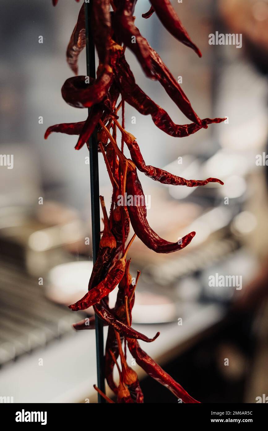 Hot peppers hanging on a hook in a typical South American restaurant ...