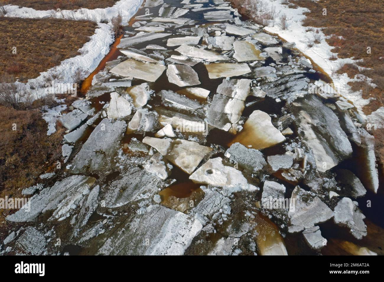 Drone shot, ice break-up, ice floes, Blackstone River, Arctic tundra ...