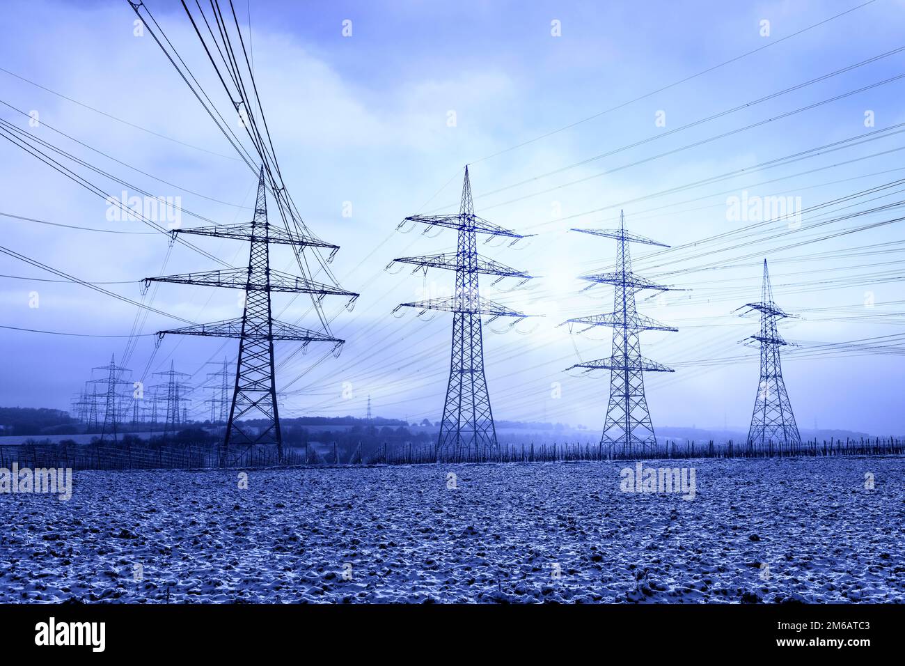 High-voltage pylons, overhead lines, power lines, winter, snow, blue ...