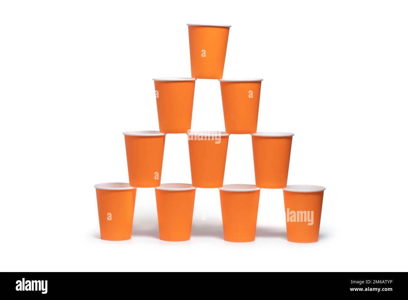 Pyramid of orange disposable paper cups isolated on white background ...