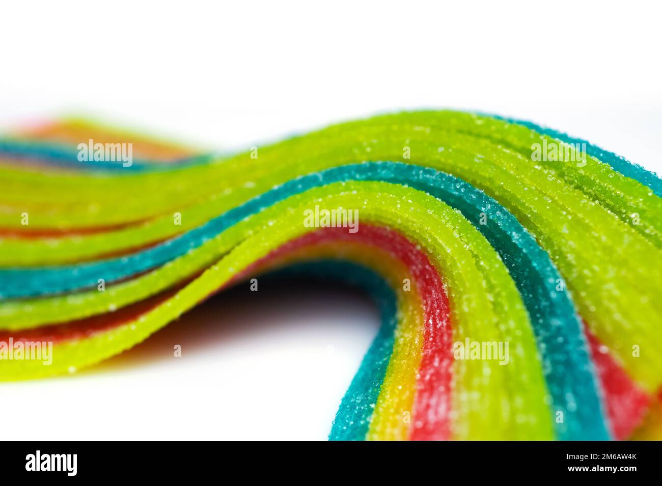 rainbow sour jelly candies strips in sugar sprinkle on white background ...