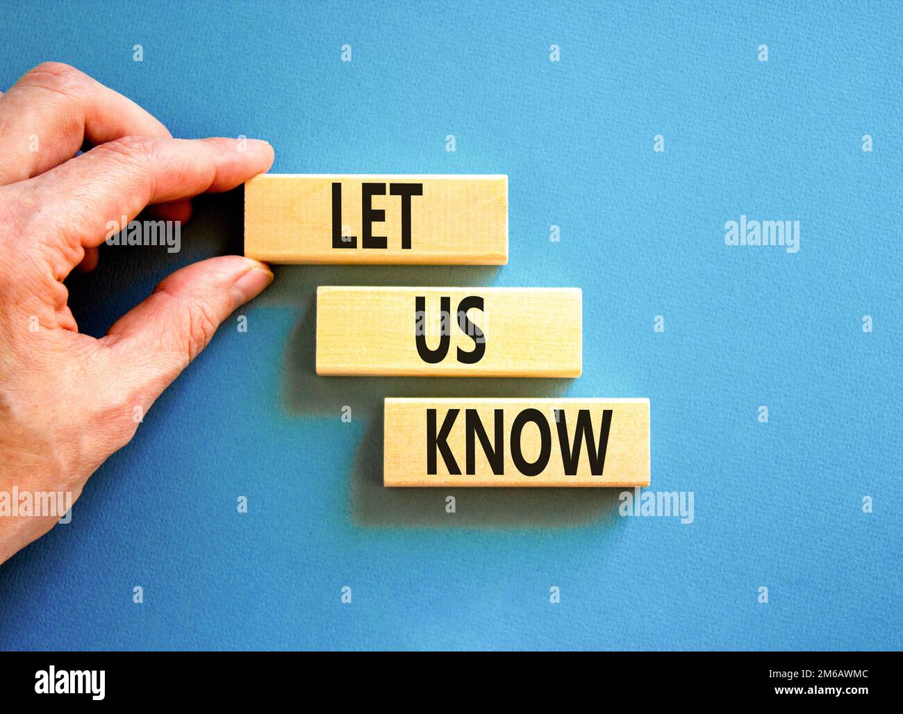 Let us know symbol. Concept words Let us know on wooden blocks on a ...