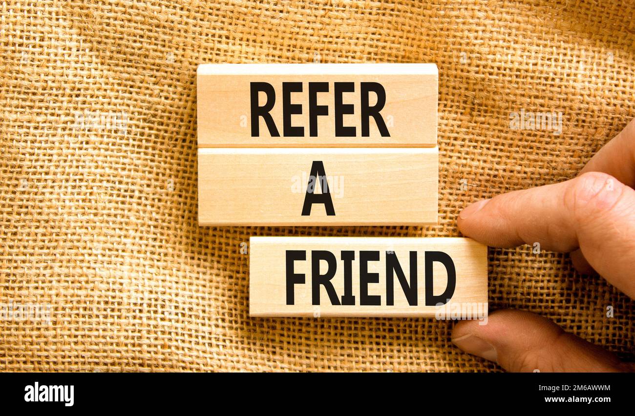 Refer a friend symbol. Concept words Refer a friend on wooden blocks on ...