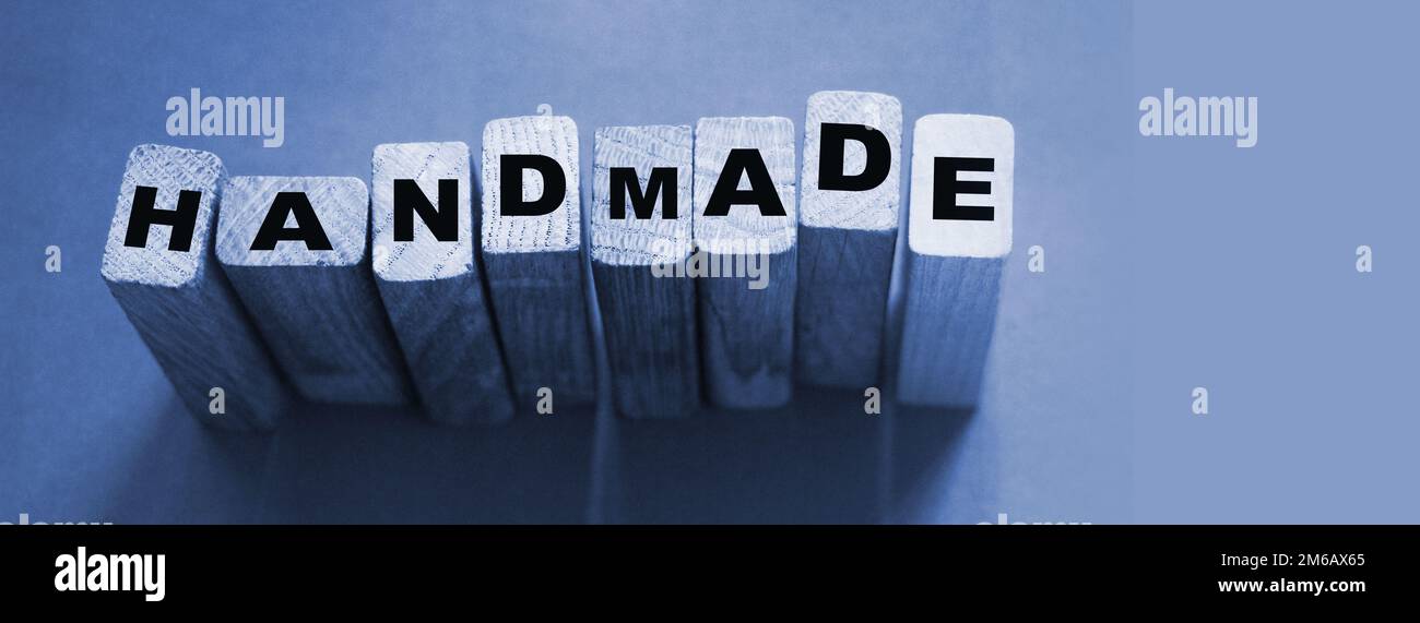 Handmade word on wooden blocks, dusty red background. Hobby handmade ...