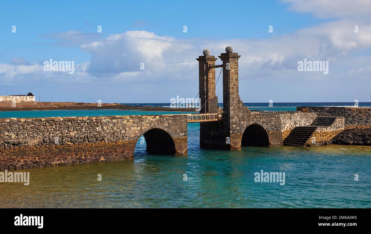 Bridge, Puente de Las Bolas, blue sky with white clouds, sea, Arrecife ...