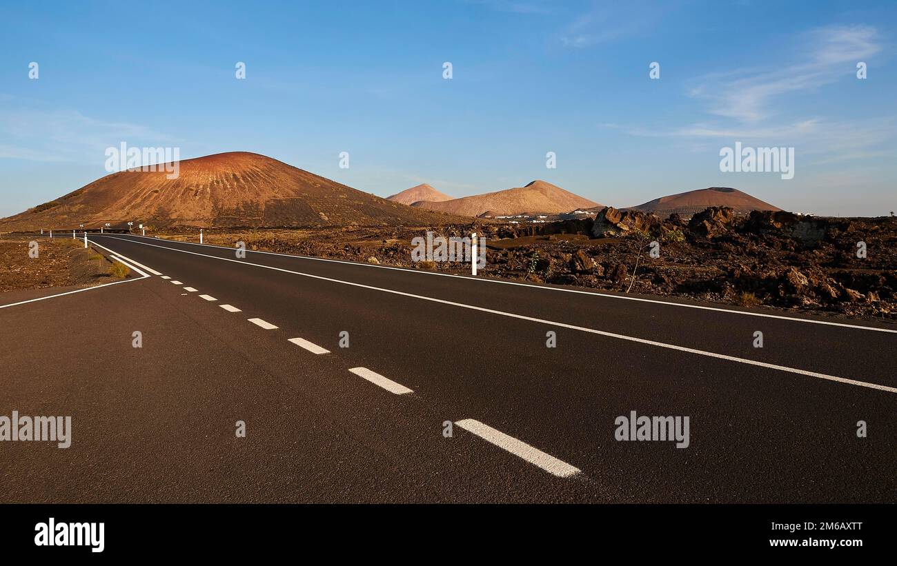 Los Vulcanos, lava landscapes with isolated volcanoes, red-brown earth ...