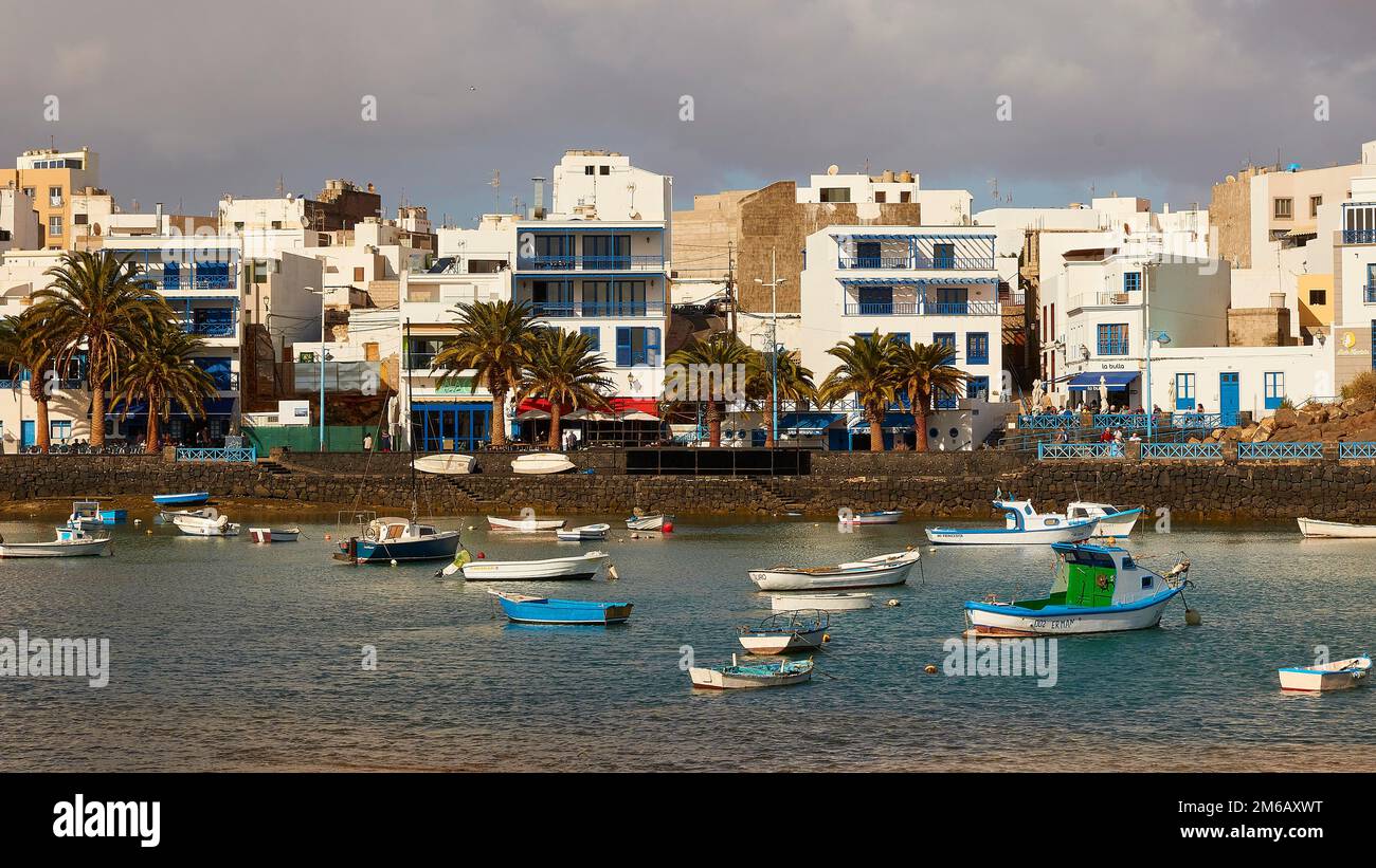 Inland harbour, boats in the water, white houses, palm trees, little ...