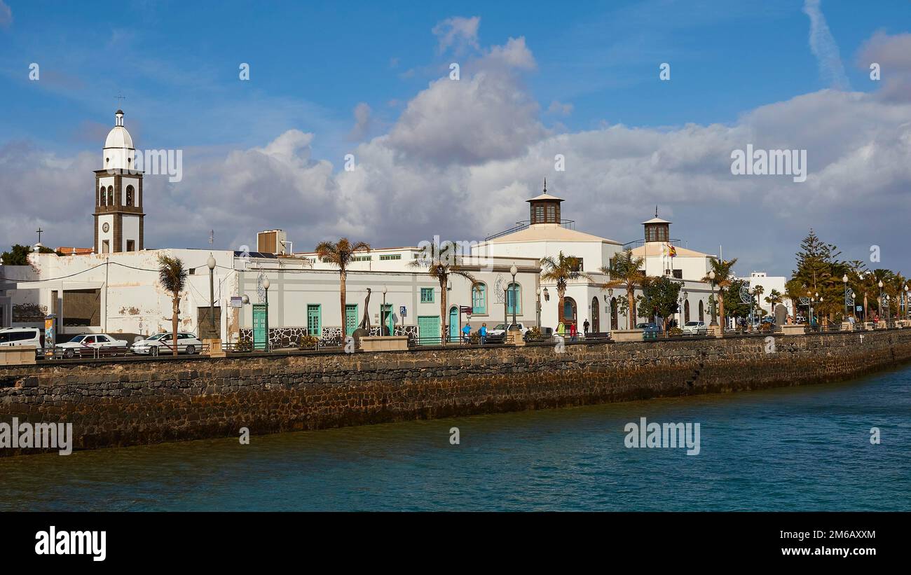 Waterfront, church tower, town hall, white building, green windows and ...