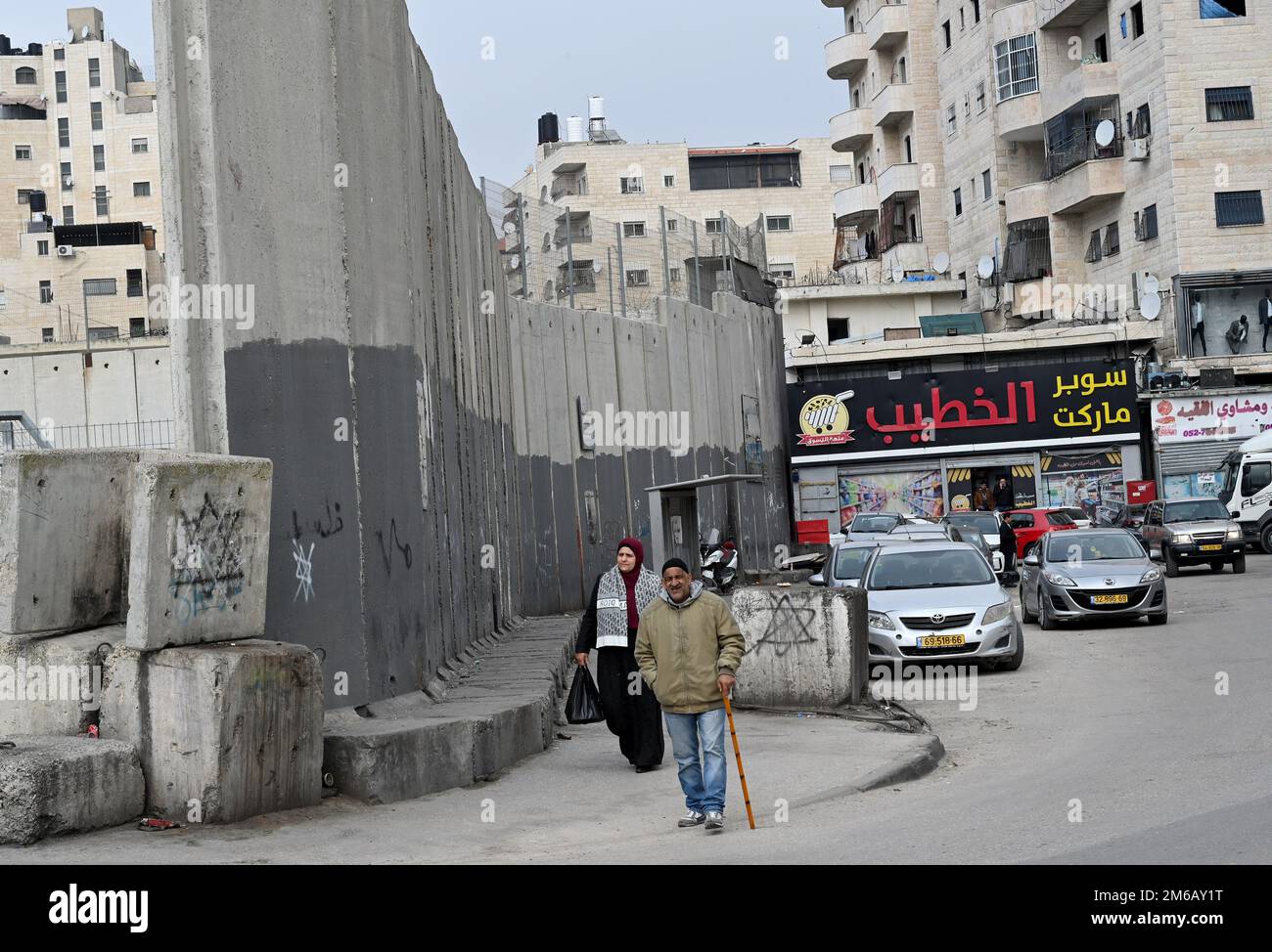 Shuafat Refugee Camp, Israel. 03rd Jan, 2023. Palestinians walk near ...