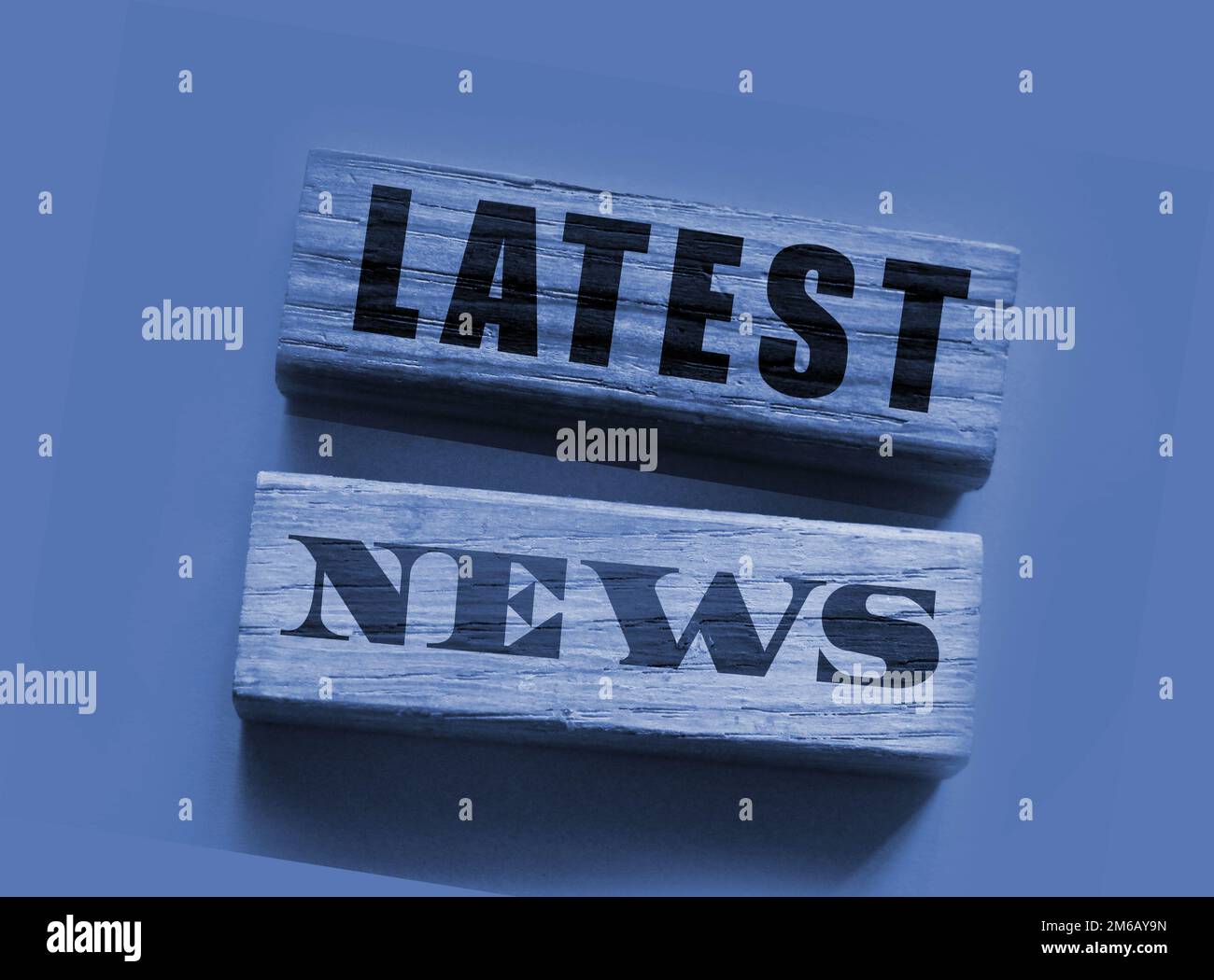 Latest News words on a wooden blocks on yellow and magenta background ...