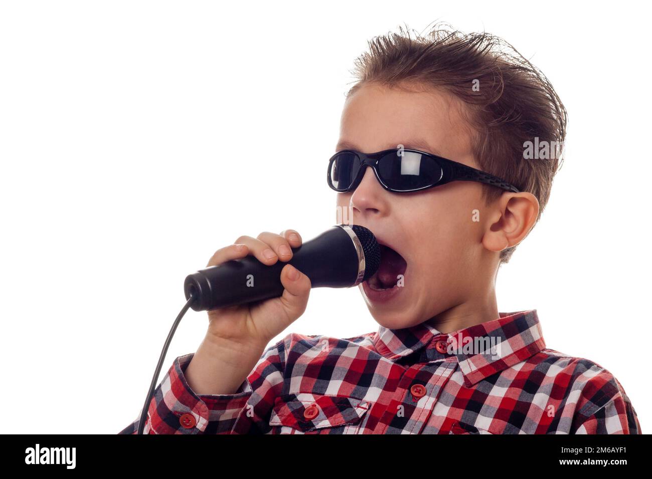 Boy yelling in microphone Stock Photo - Alamy