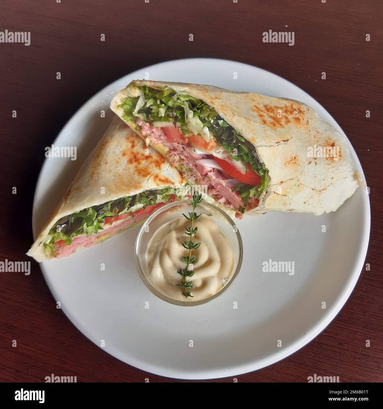 A top view of a tasty wrap with salmon, vegetables and sauce Stock ...