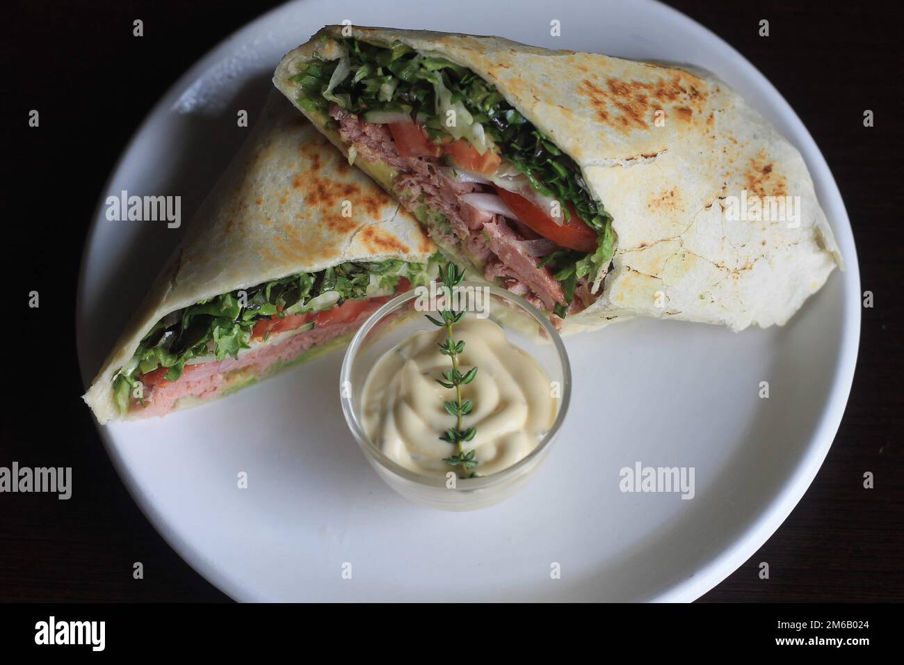 A top view of a tasty wrap with salmon, vegetables and sauce Stock ...