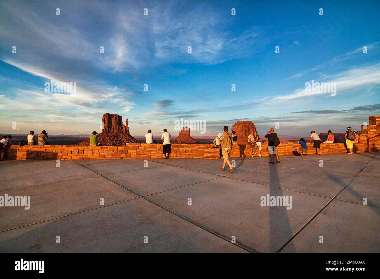 Visitors enjoy sunset on viewing platform, visitor centre at Monument ...