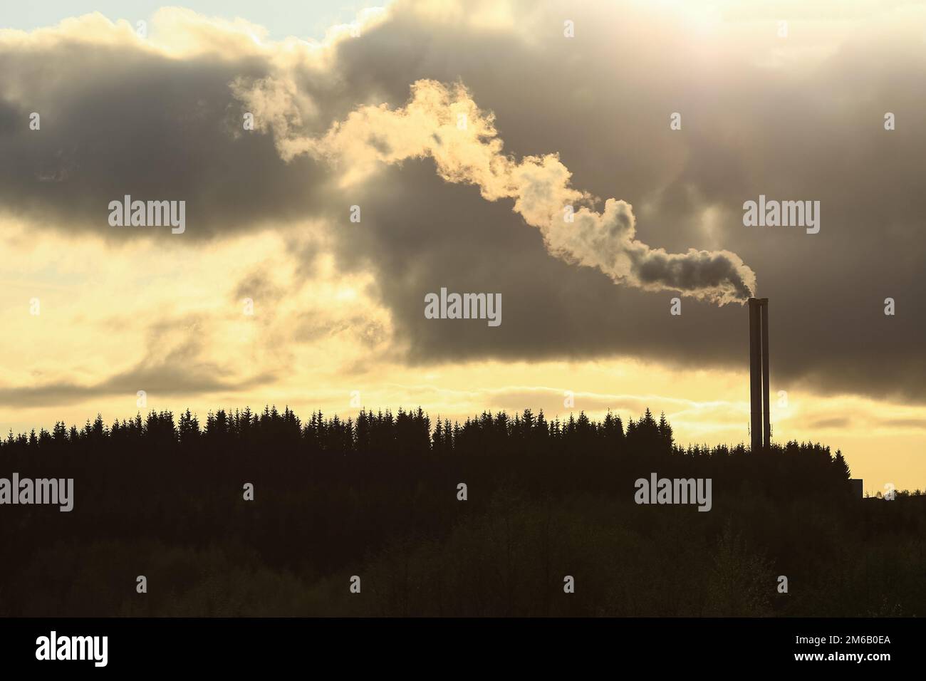 Heat station pipe on the background of dramatic cloudy sky as a concept ...