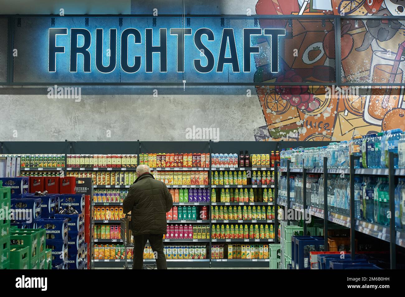 Man in front of fruit juice, shelf with drinks, Edeka-Meyers, 24537 ...