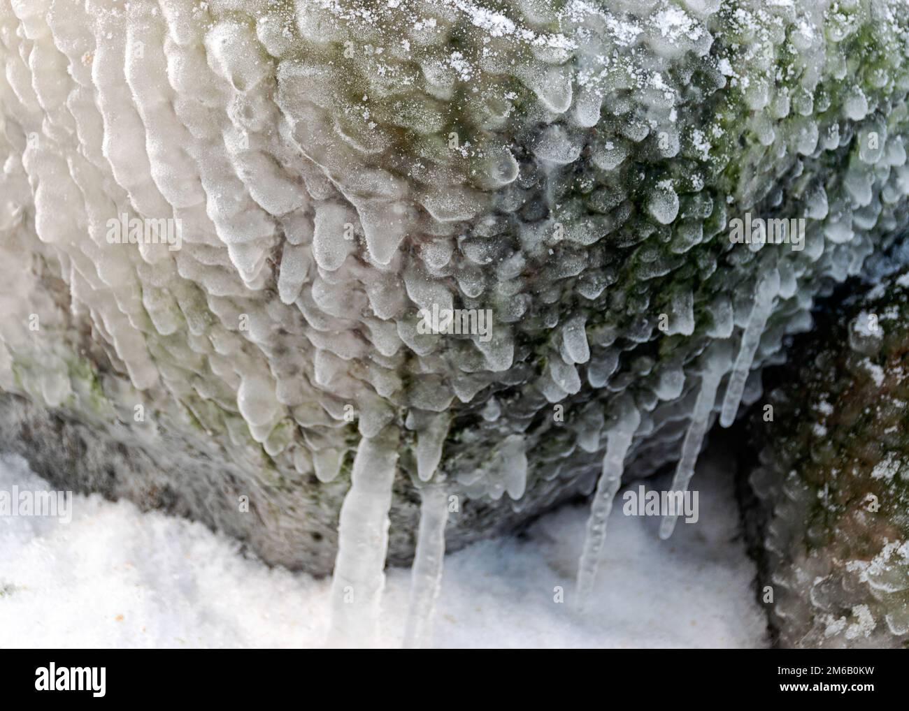 different ice formations on rocks on the seashore, ice texture, wind ...