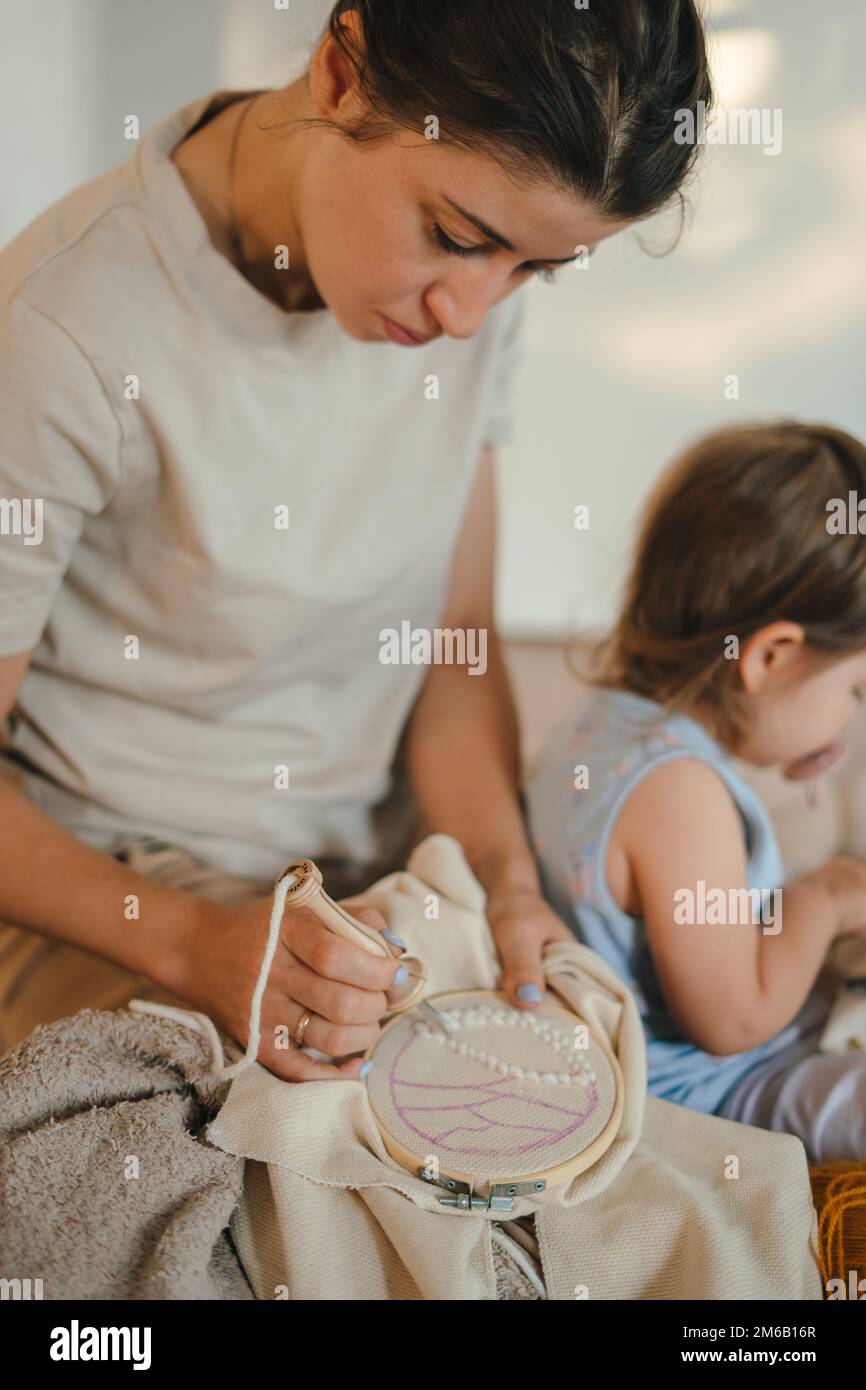 Mother and child girl knit at home, handmade and handicraft concept ...