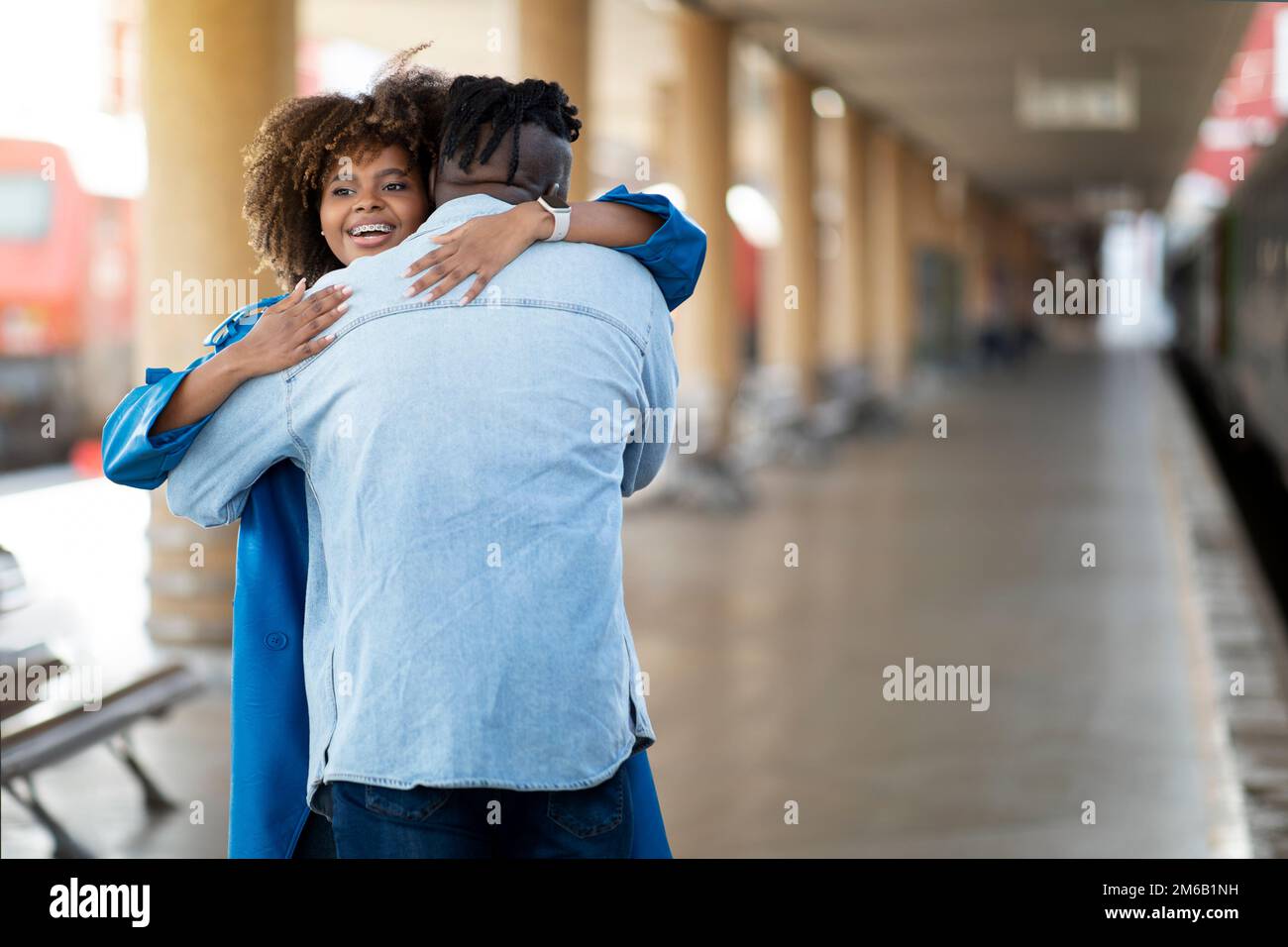 Happy Reunion. Joyful Black Woman Hugging Boyfriend At Railway Station ...