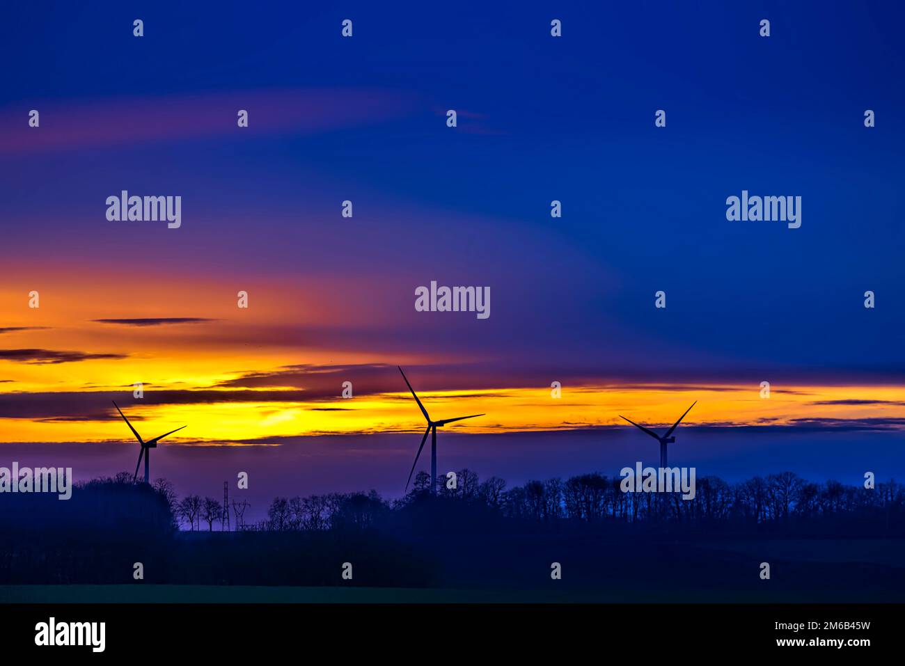 Fresnay l'eveque, France. 3rd Jan, 2023. Sunset over the wind turbines ...