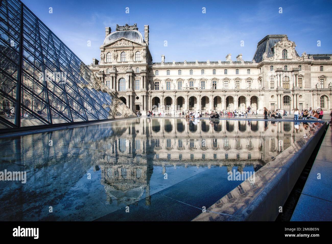 Tourists congregate near a reflecting pool in the inner courtyard at ...