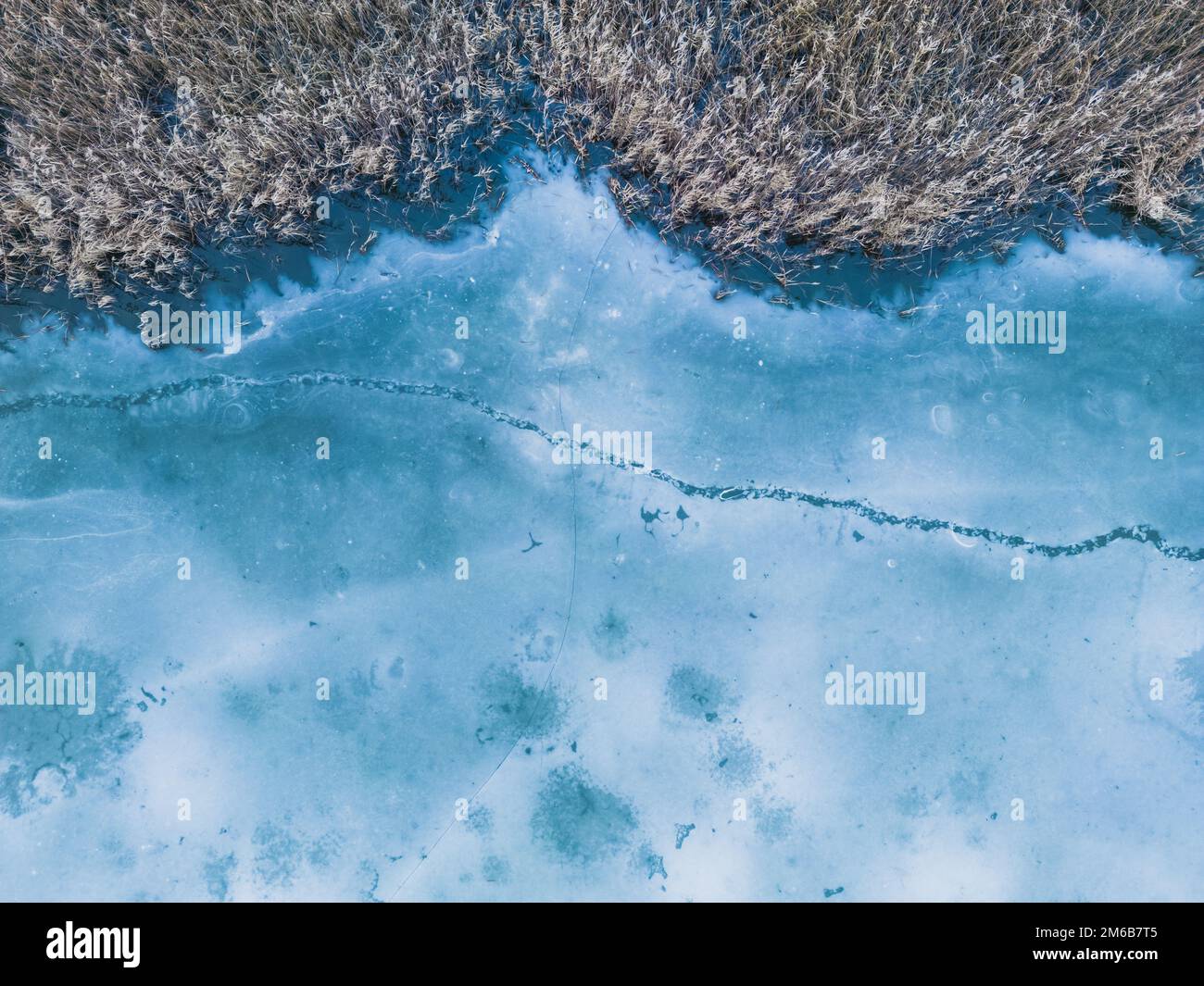 Aerial view of a frozen lake. Ice sheet background. Frozen waves on the ...