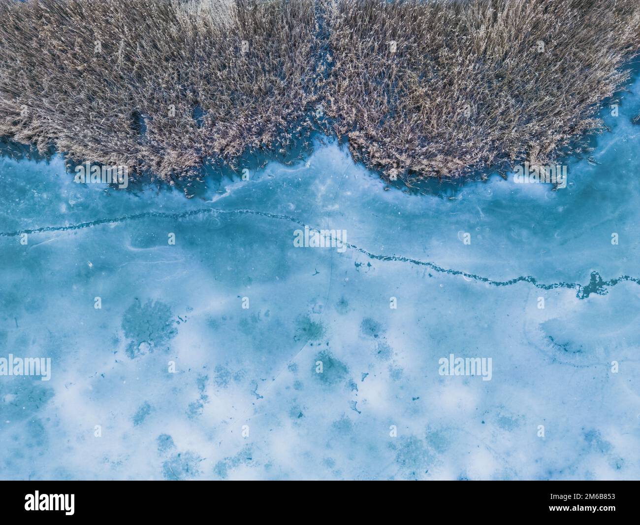 Aerial view of a frozen lake. Ice sheet background. Frozen waves on the ...