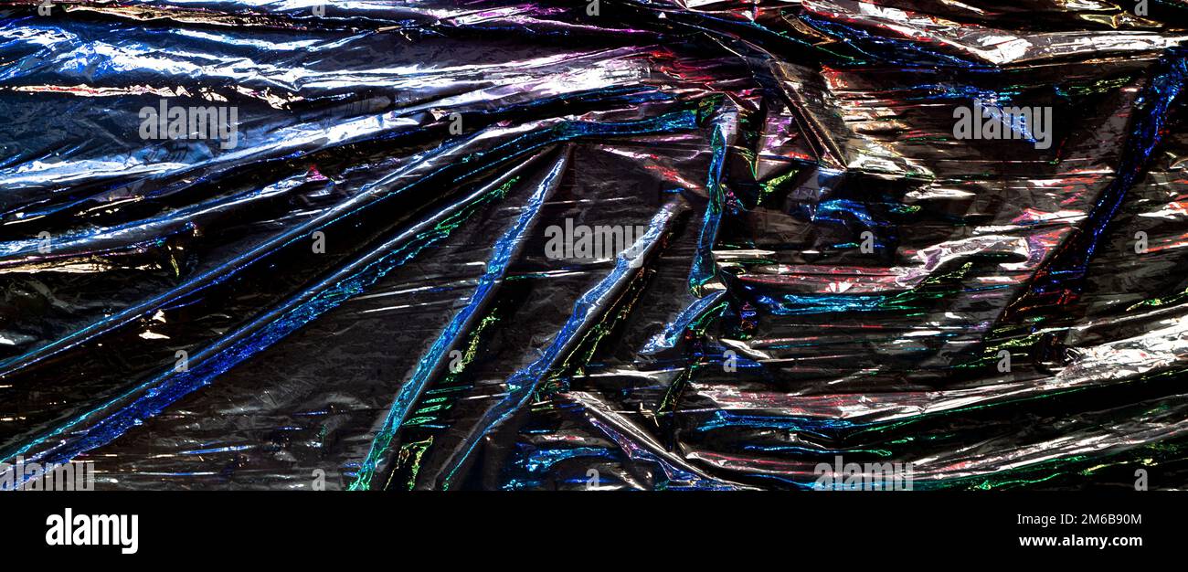 Black color plastic wrap background. Dark crumpled wrinkled plastic ...