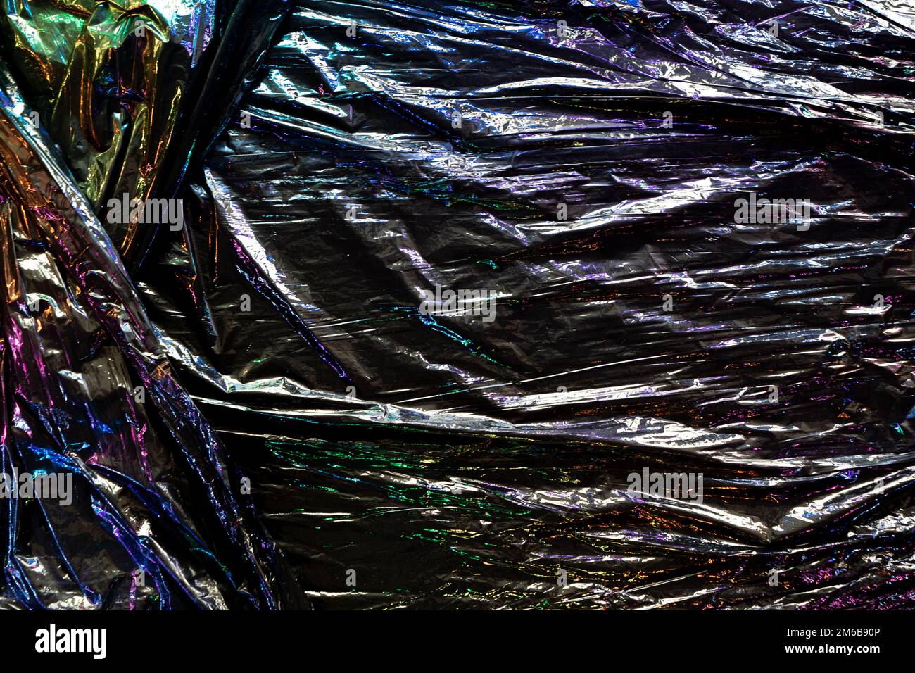 Black color plastic wrap background. Dark crumpled wrinkled plastic ...