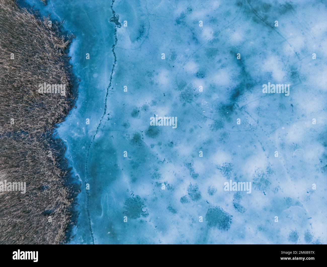 Aerial view of a frozen lake. Ice sheet background. Frozen waves on the ...