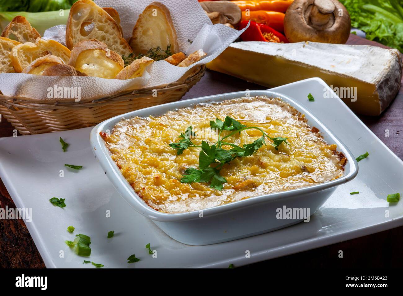 Lasagna Bolognese baked in the wood oven Stock Photo - Alamy