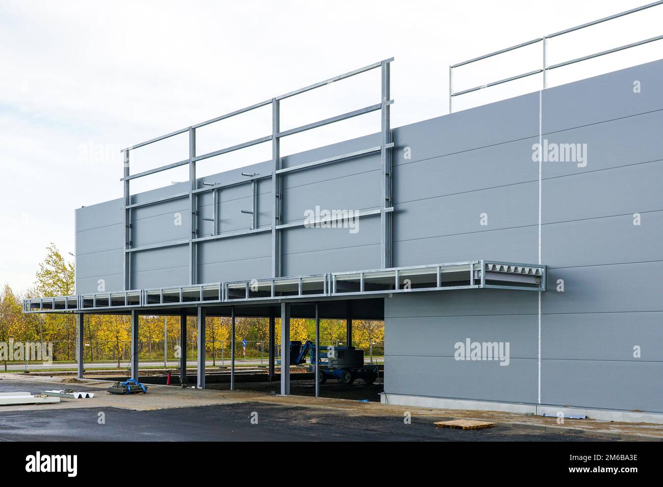Unfinished modern metal frame warehouse building facade covered with ...
