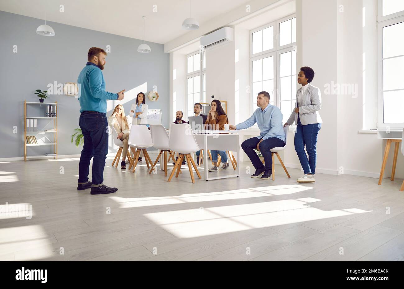 Corporate manager talking to a diverse business team during a meeting ...