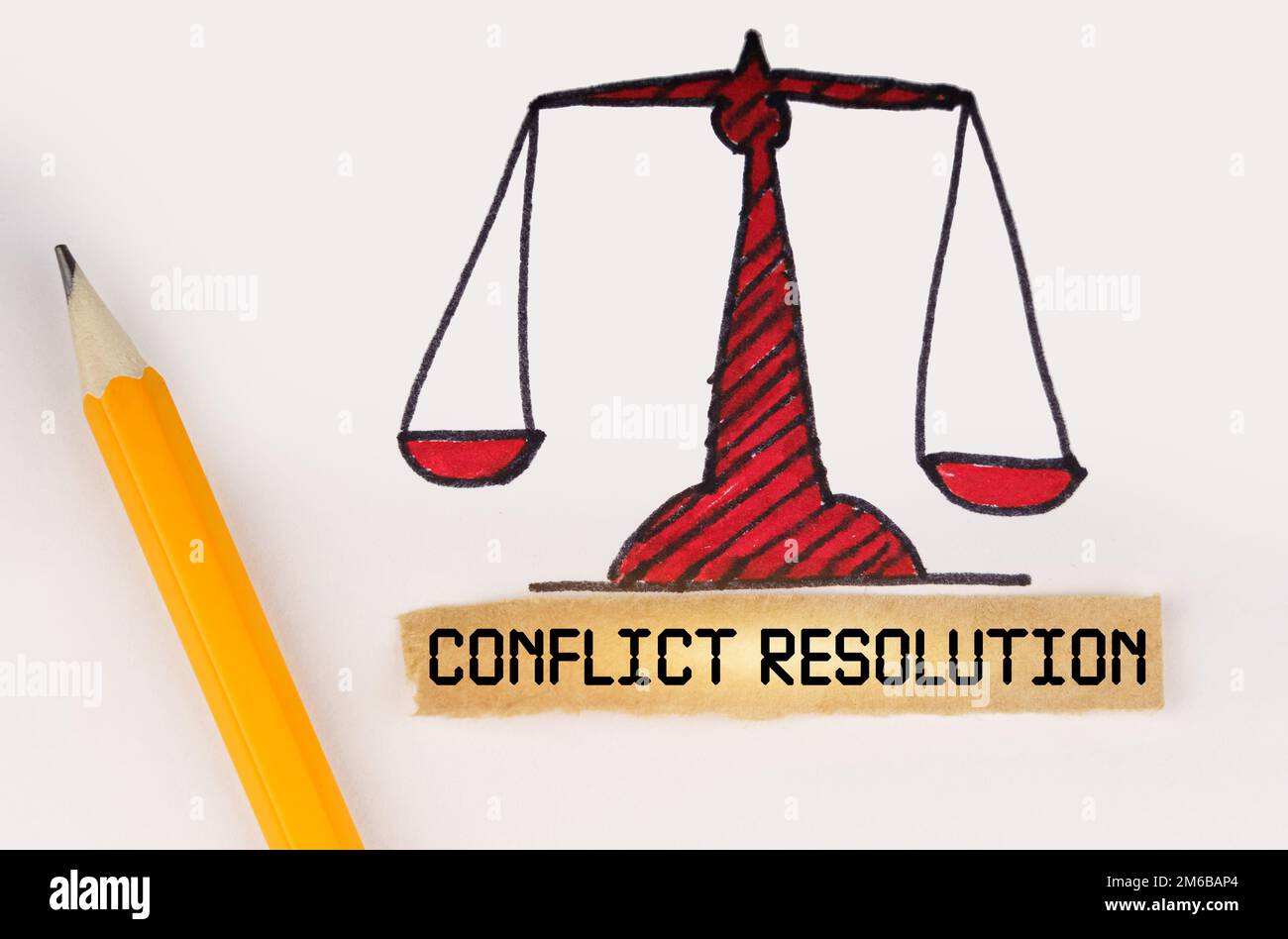 Legal concept. Next to the painted scales of justice lies a pencil and ...